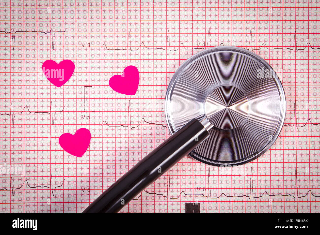 Hearts of paper and medical stethoscope lying on electrocardiogram ...