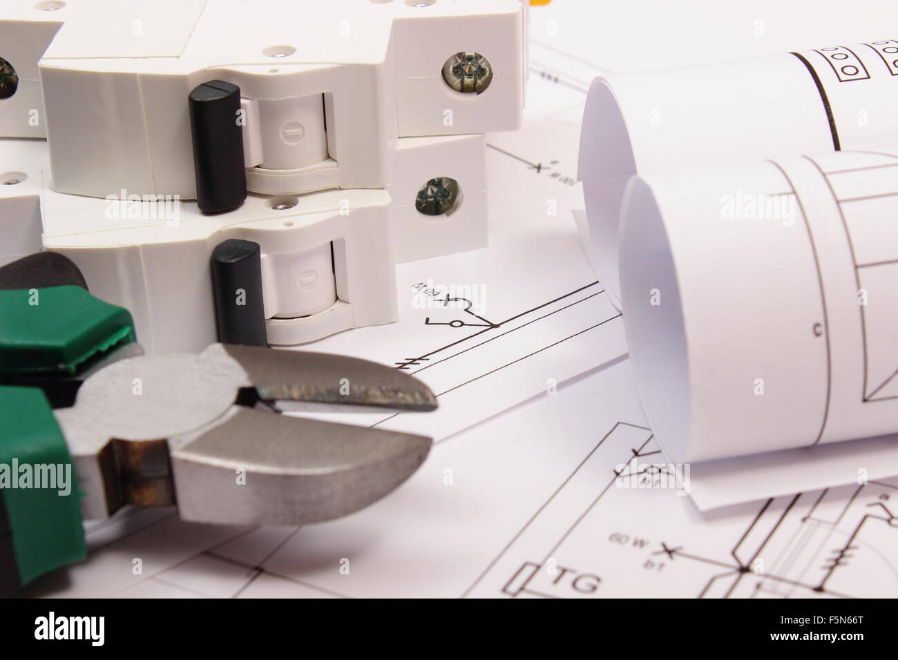 Metal pliers, electric fuse and rolls of diagrams on electrical ...