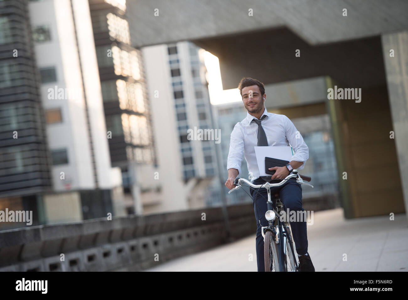 Man riding bicycle on city street Stock Photo - Alamy