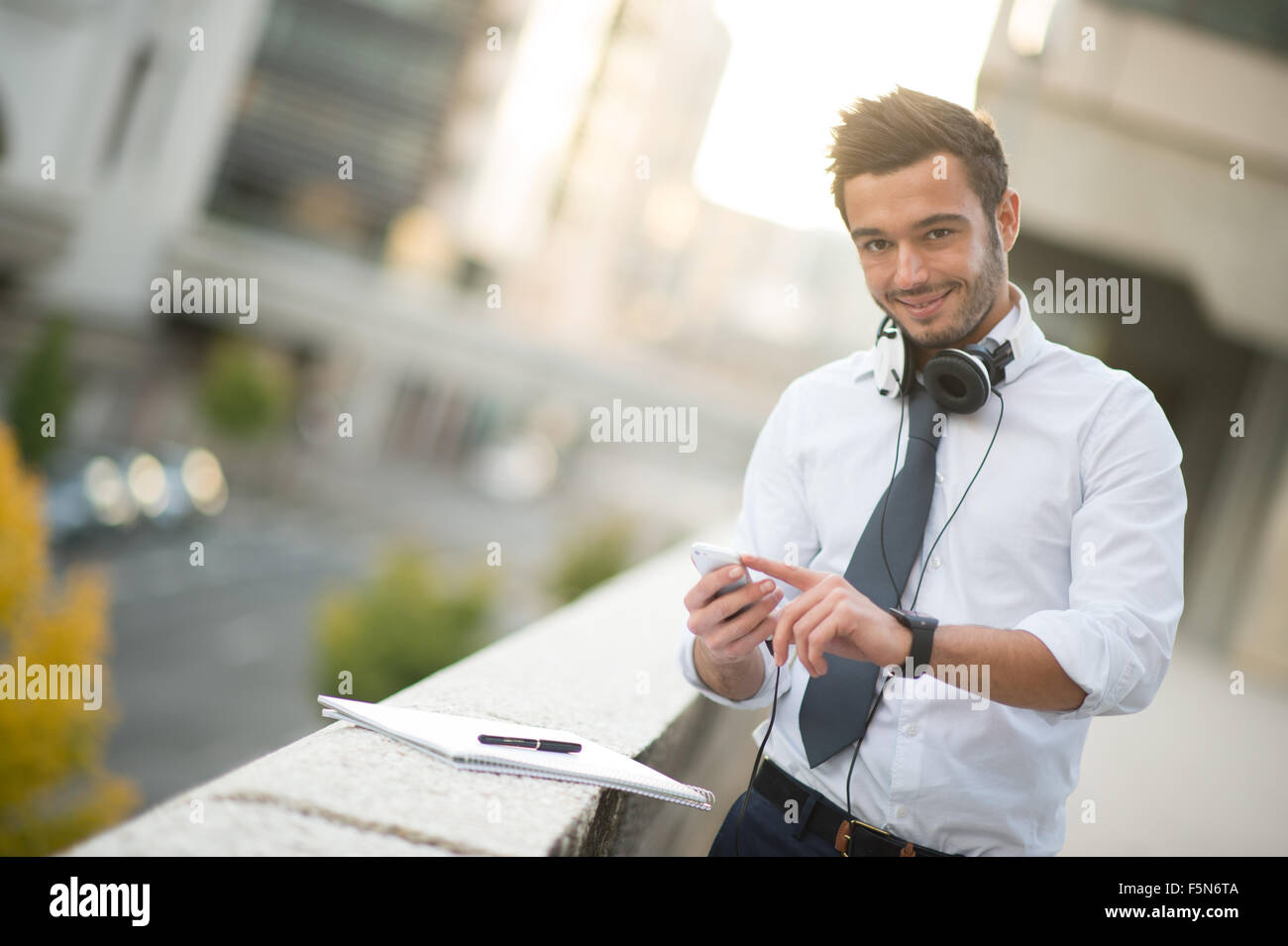 Businessman taking notes on a notebook in the city Stock Photo - Alamy