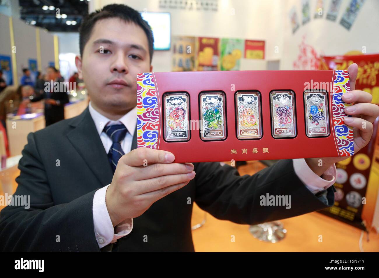 Beijing, China. 7th Nov, 2015. An exhibitor shows silver badges during ...