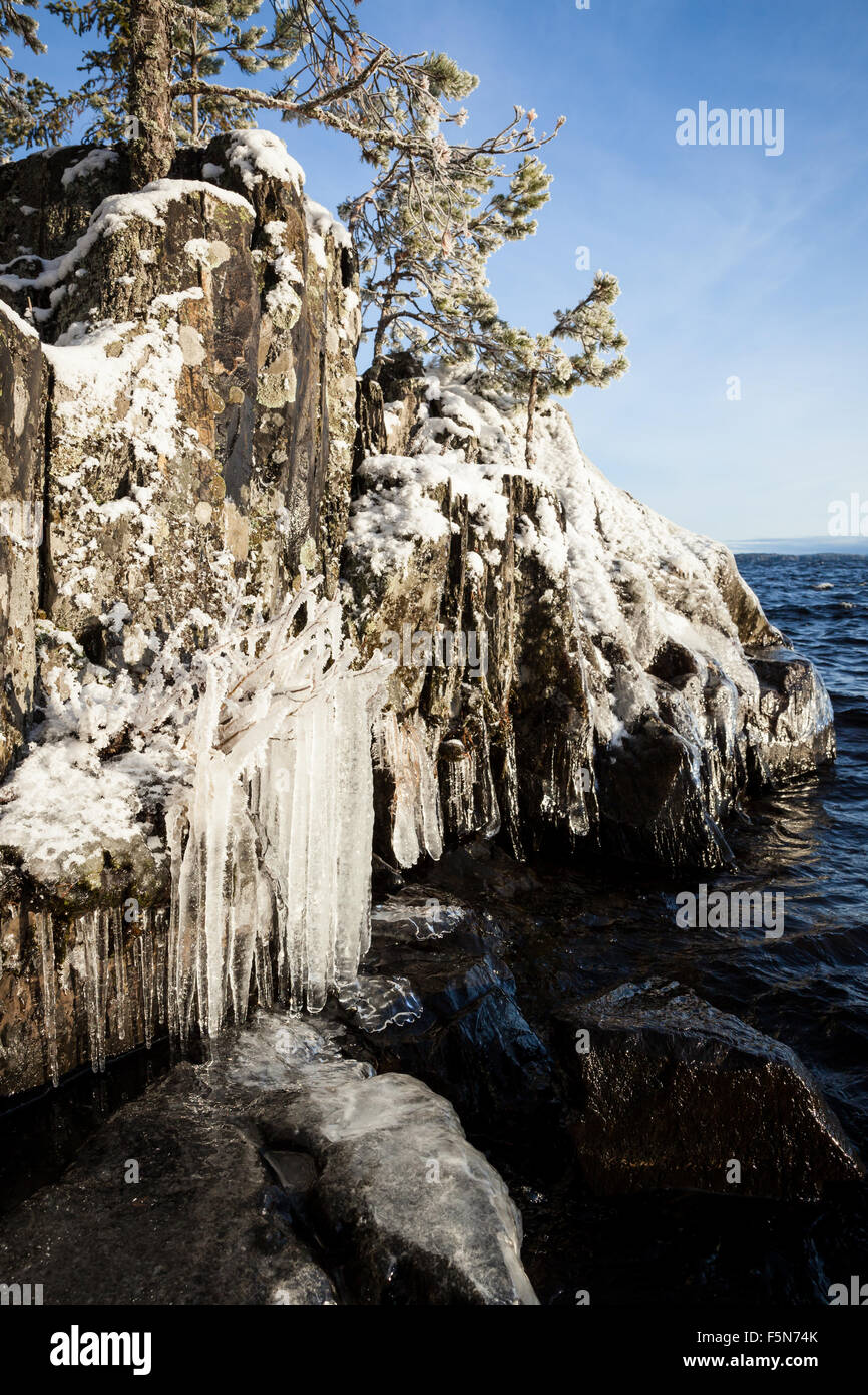 Frozen lakefront rock cliff Stock Photo - Alamy