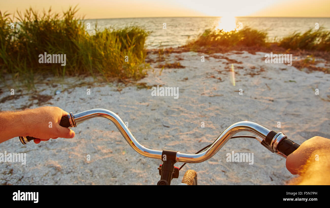 the hands holding handlebar of a bicycle Stock Photo - Alamy
