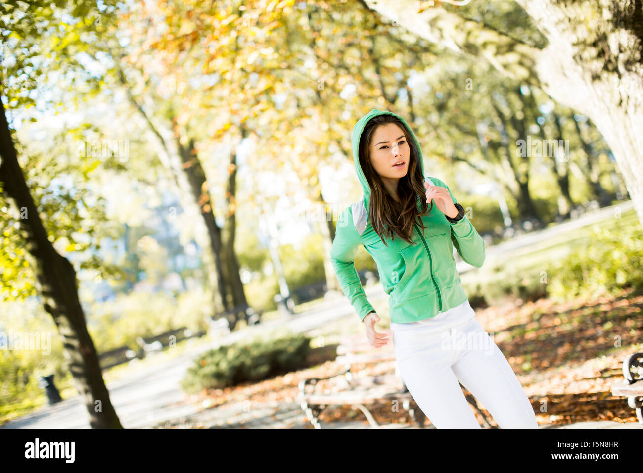 Young woman running in the park Stock Photo - Alamy