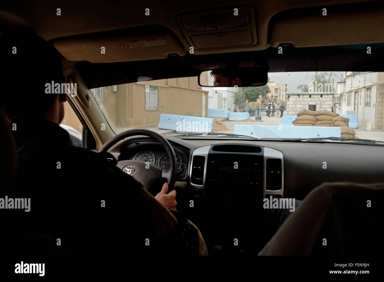 A driver drives into the guarded compound of the Kurdish People's ...
