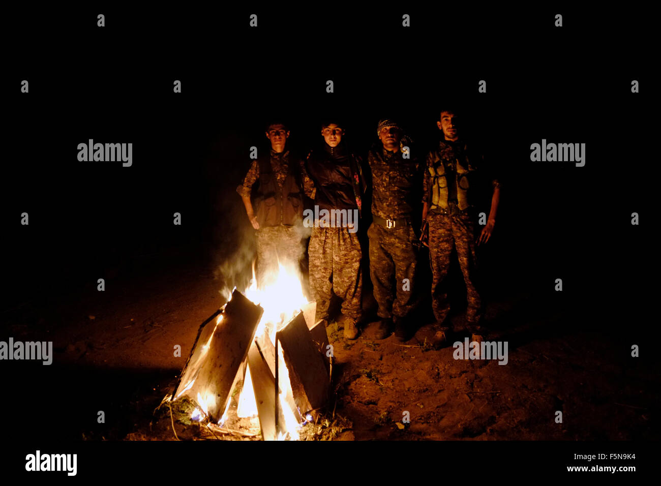 Fighters of the Kurdish People's Protection Units YPG standing around a ...