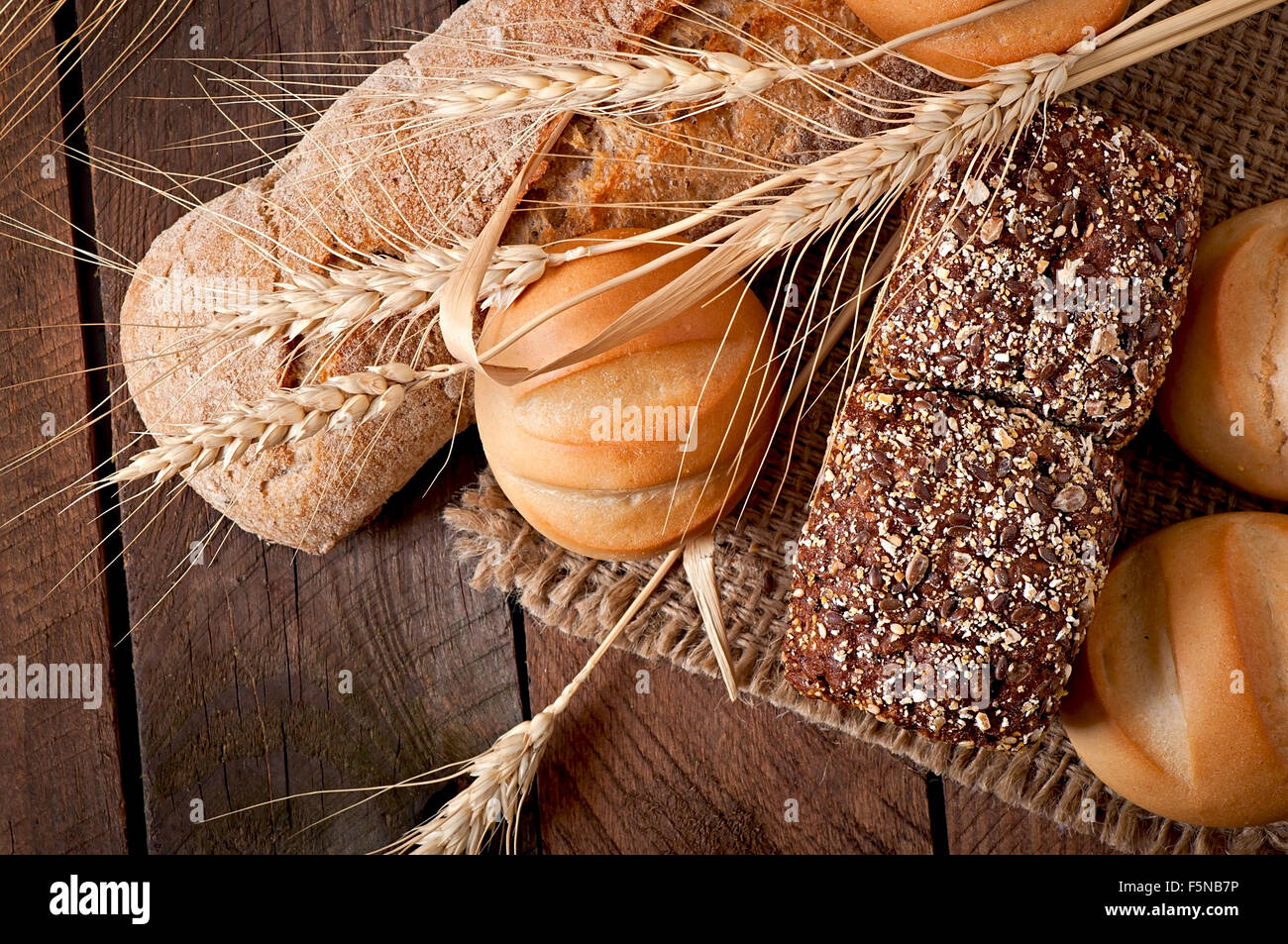 Assortment of baked bread on a wooden table Stock Photo - Alamy