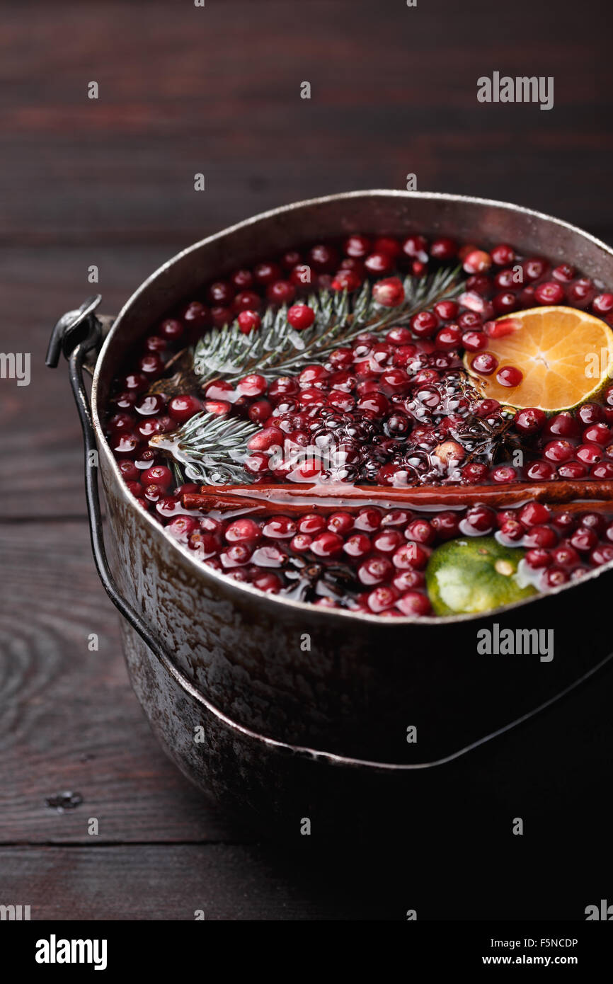 Bubbling cranberry mandarin pomegranate punch or mulled wine in a ...