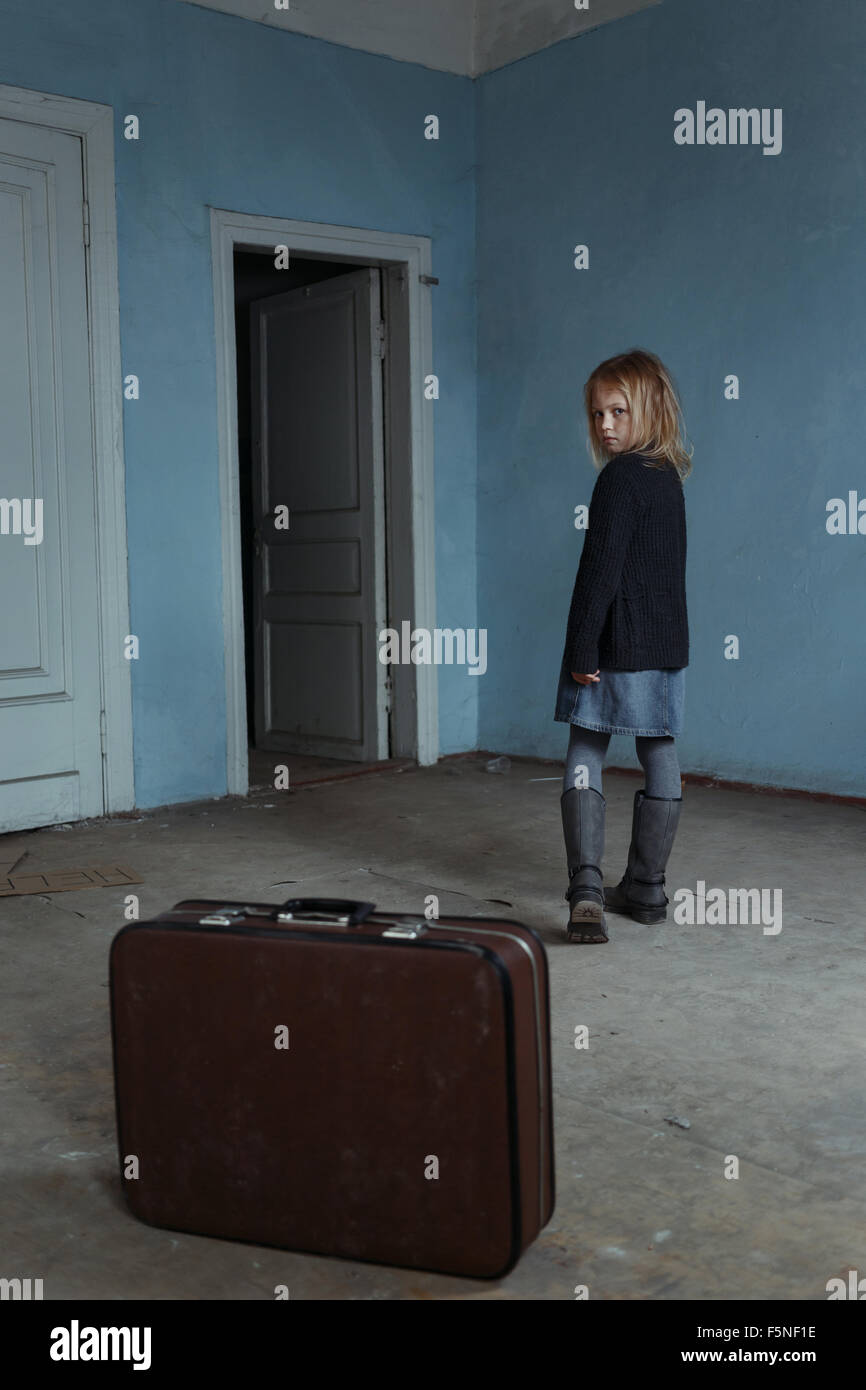 Miserable girl leaving the room Stock Photo - Alamy