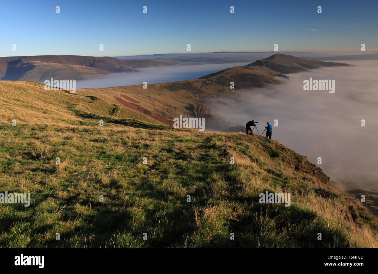 2 photographers photographing a temperature inversion on Mam Tor in the ...