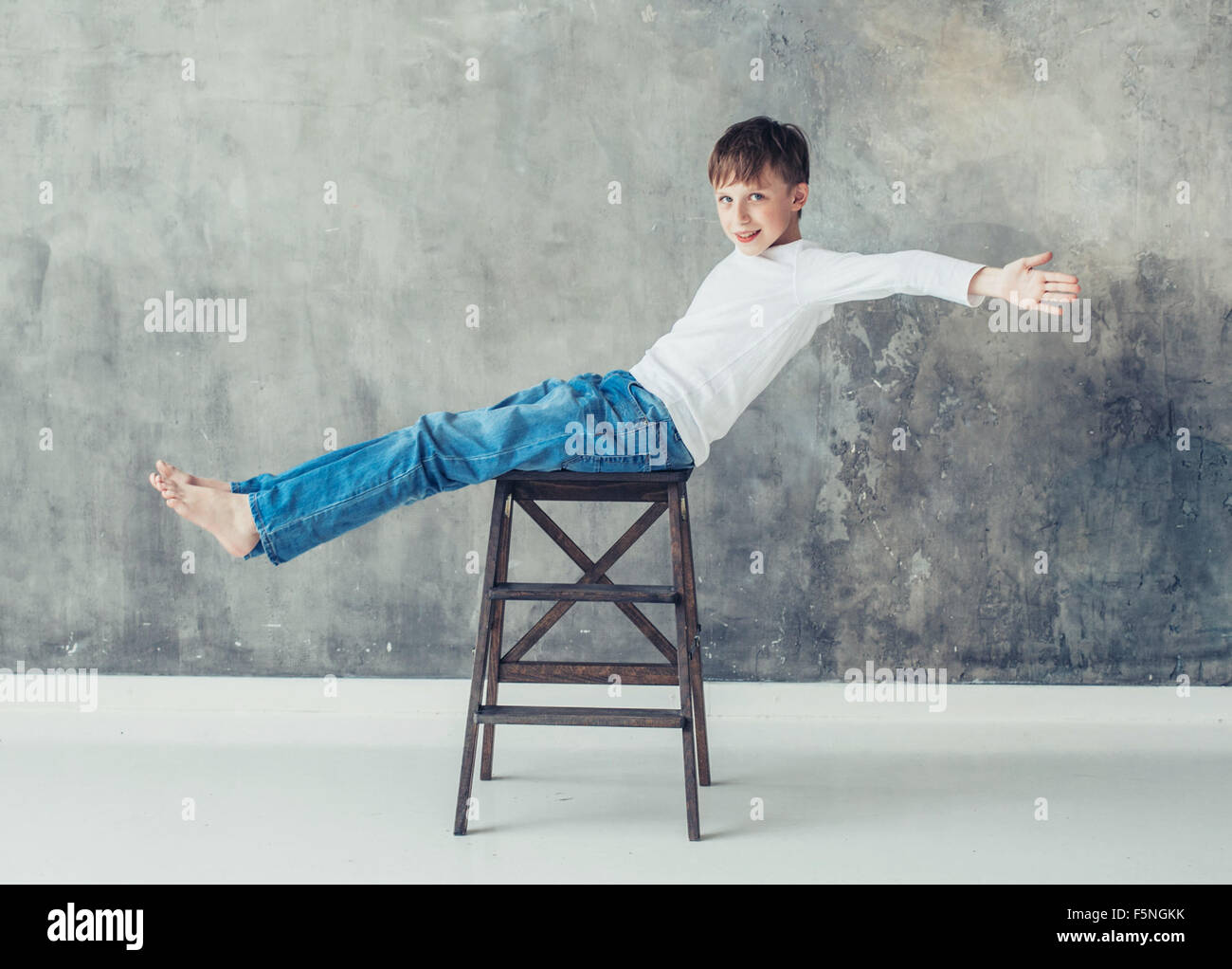 Cute boy happy beautiful child closeup portrait sitting studio gray ...