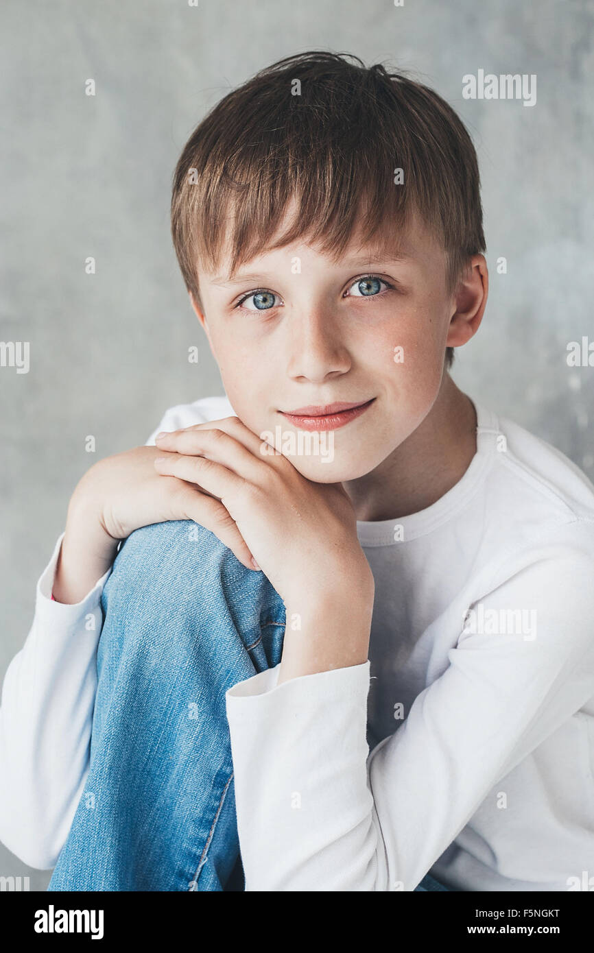 Cute boy happy beautiful child closeup portrait studio sitting gray ...