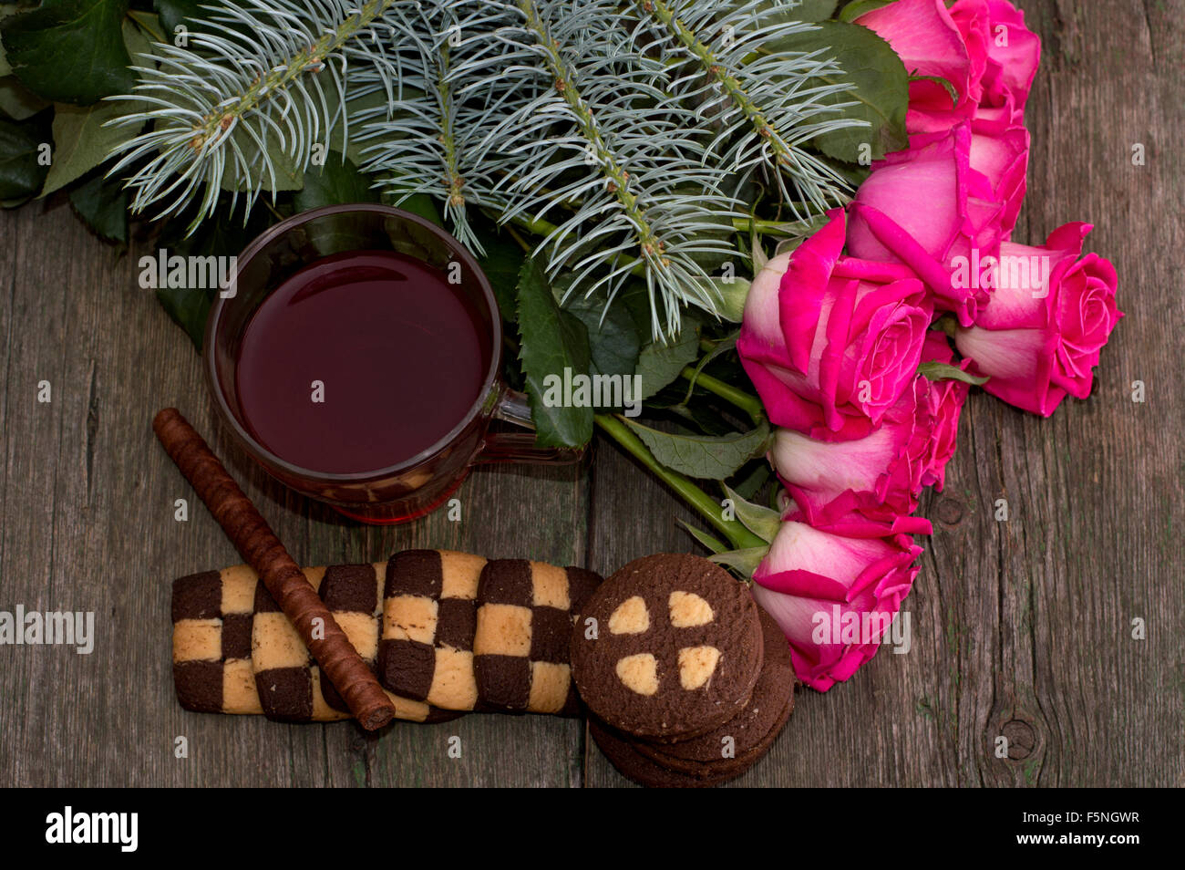fir-tree branch, tea, roses and linking of cookies Stock Photo - Alamy