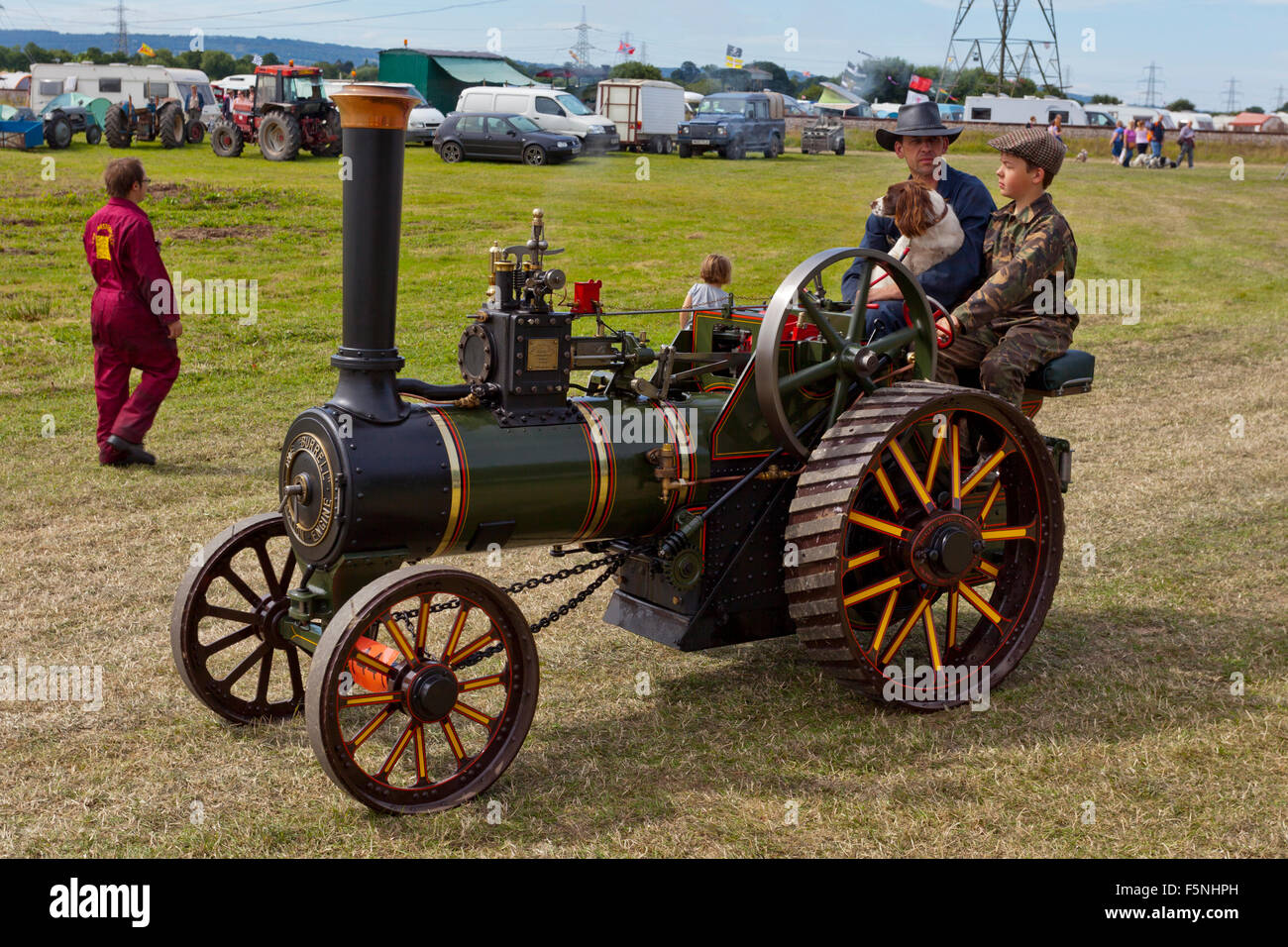 Miniature traction engine being driven by father and son (and dog) at ...