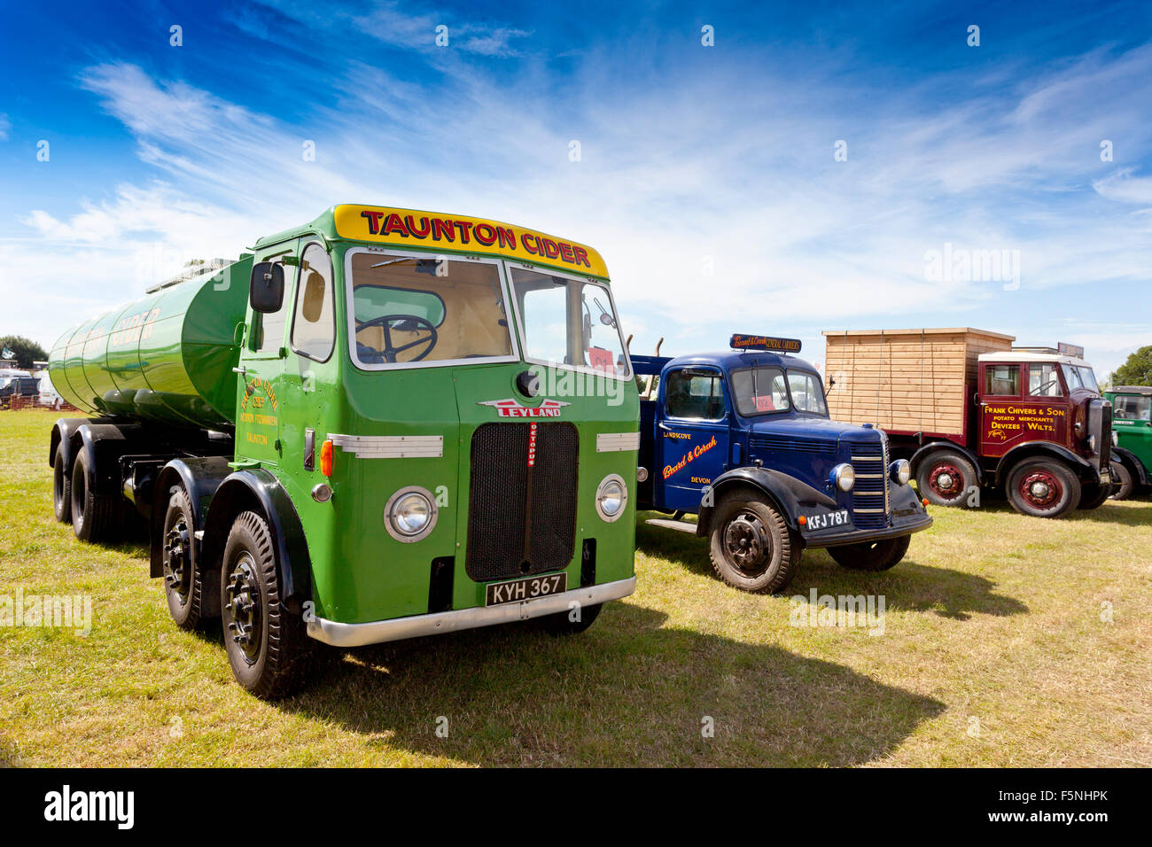 A line-up of vintage road wagons including a tanker for delivering ...