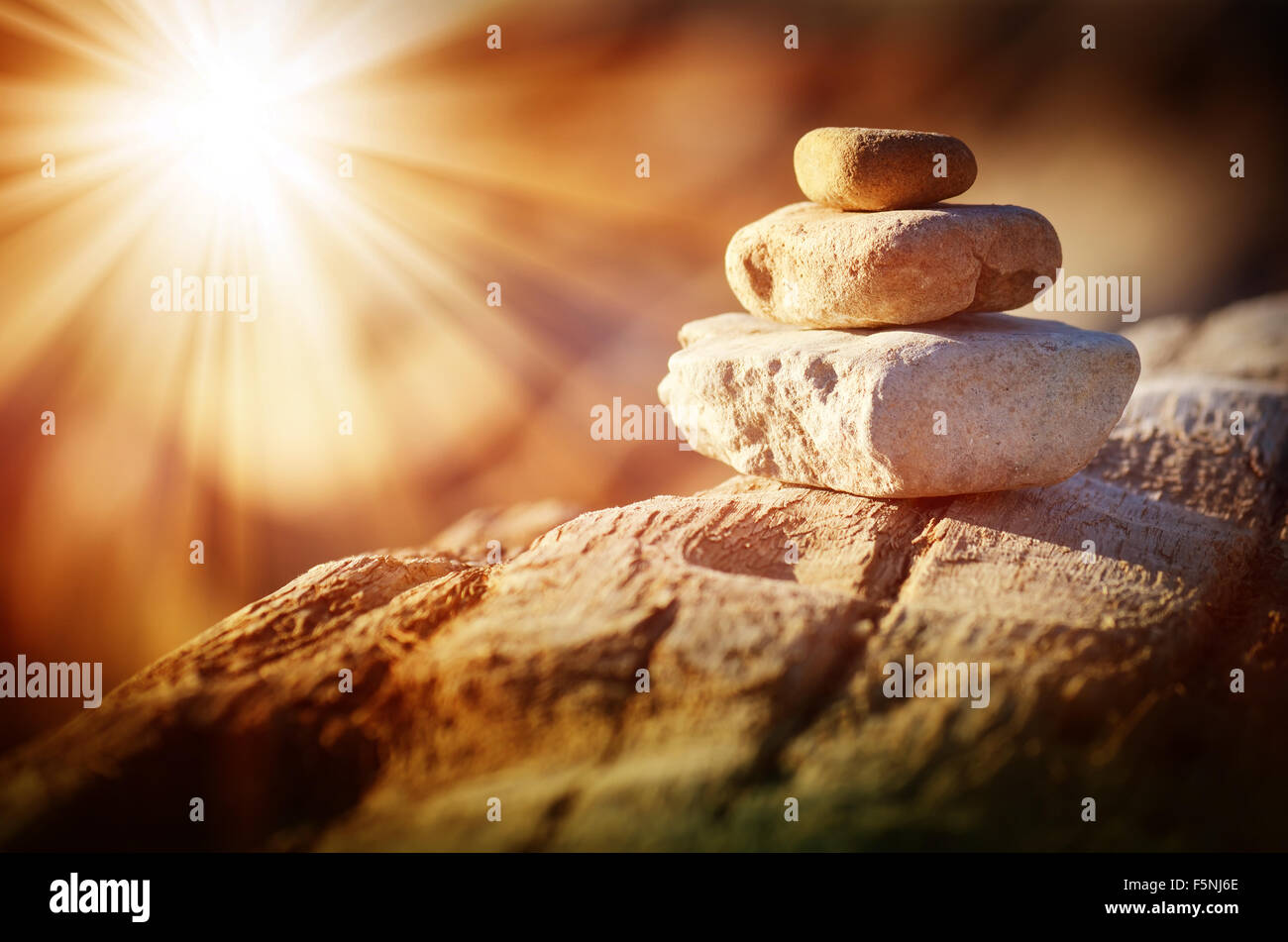 three stones lighted bright sun Stock Photo - Alamy