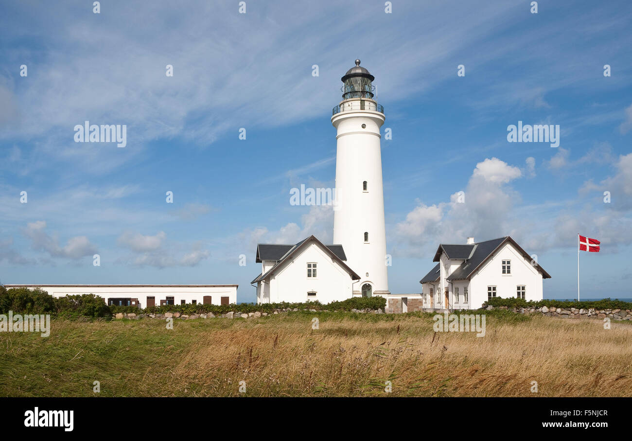 A traditional Danish lighthouse stands on the coast in all its ...