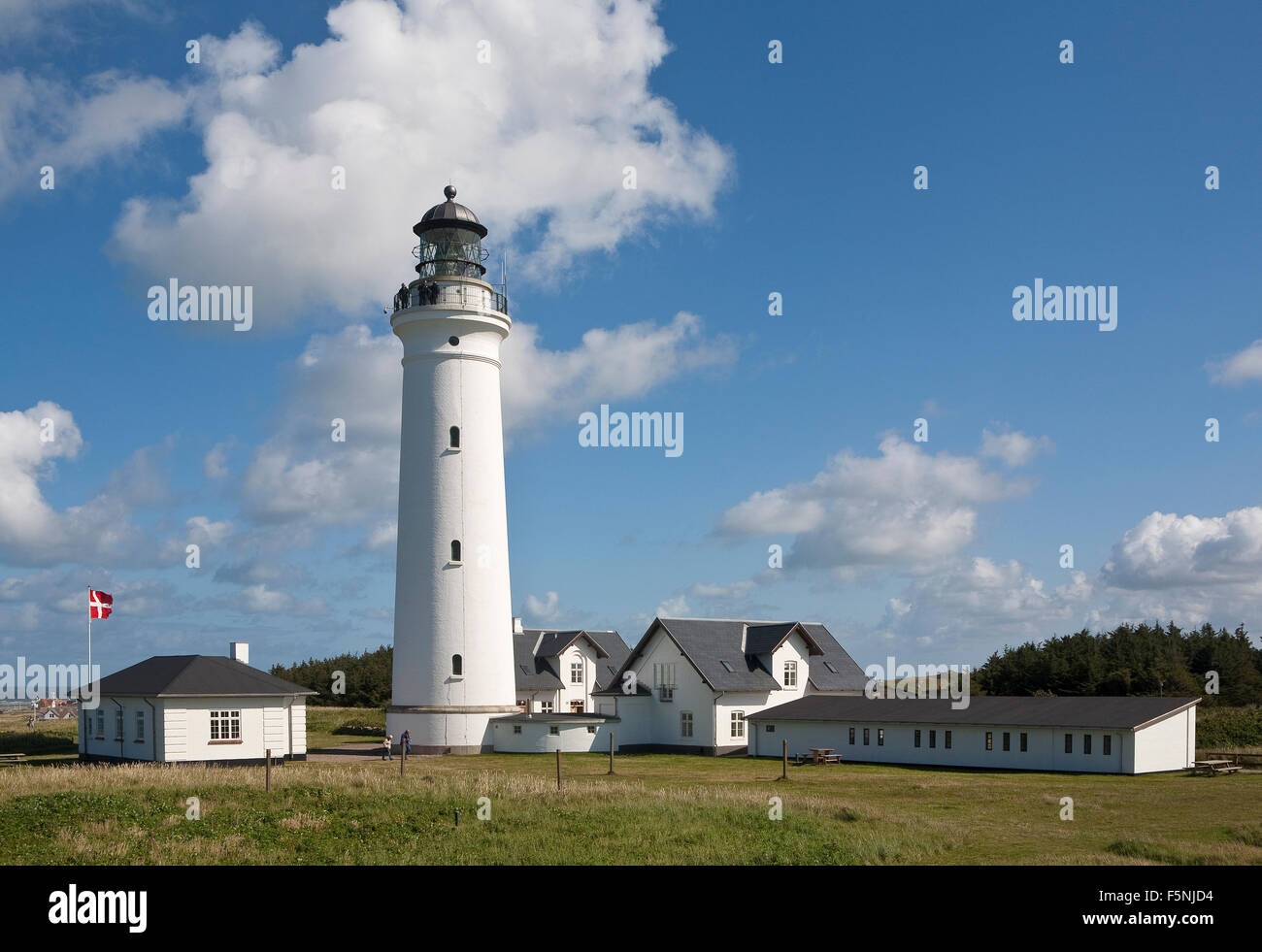 A grand lighthouse stands guard over the coastline. The lighthouse has ...