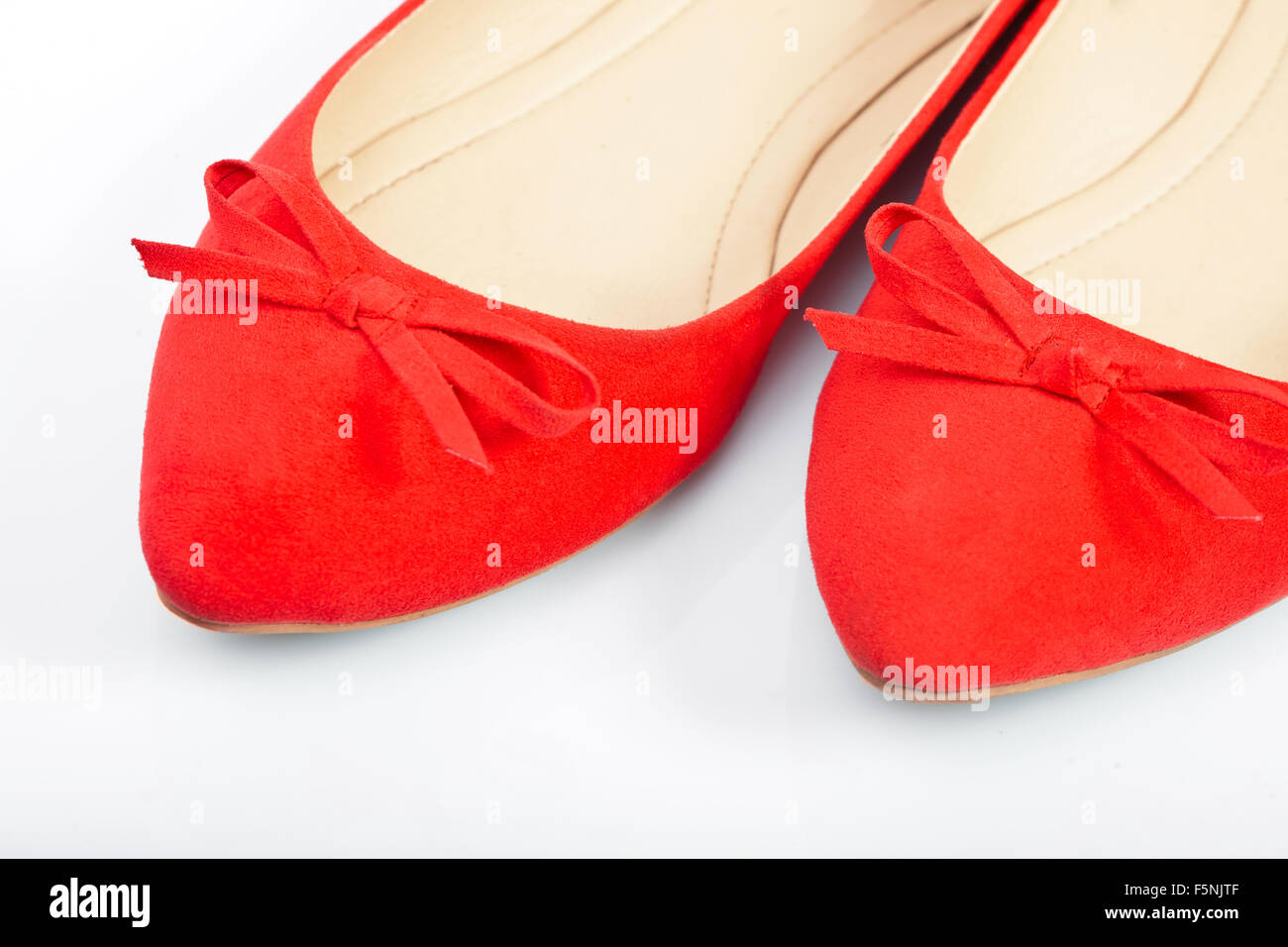 Pair of red female shoes over white background Stock Photo - Alamy