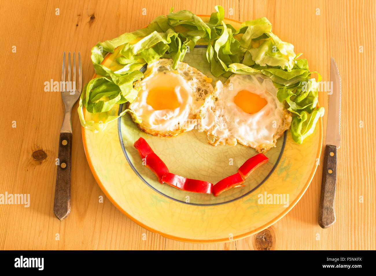 Smiley breakfast of eggs and lettuce Stock Photo - Alamy