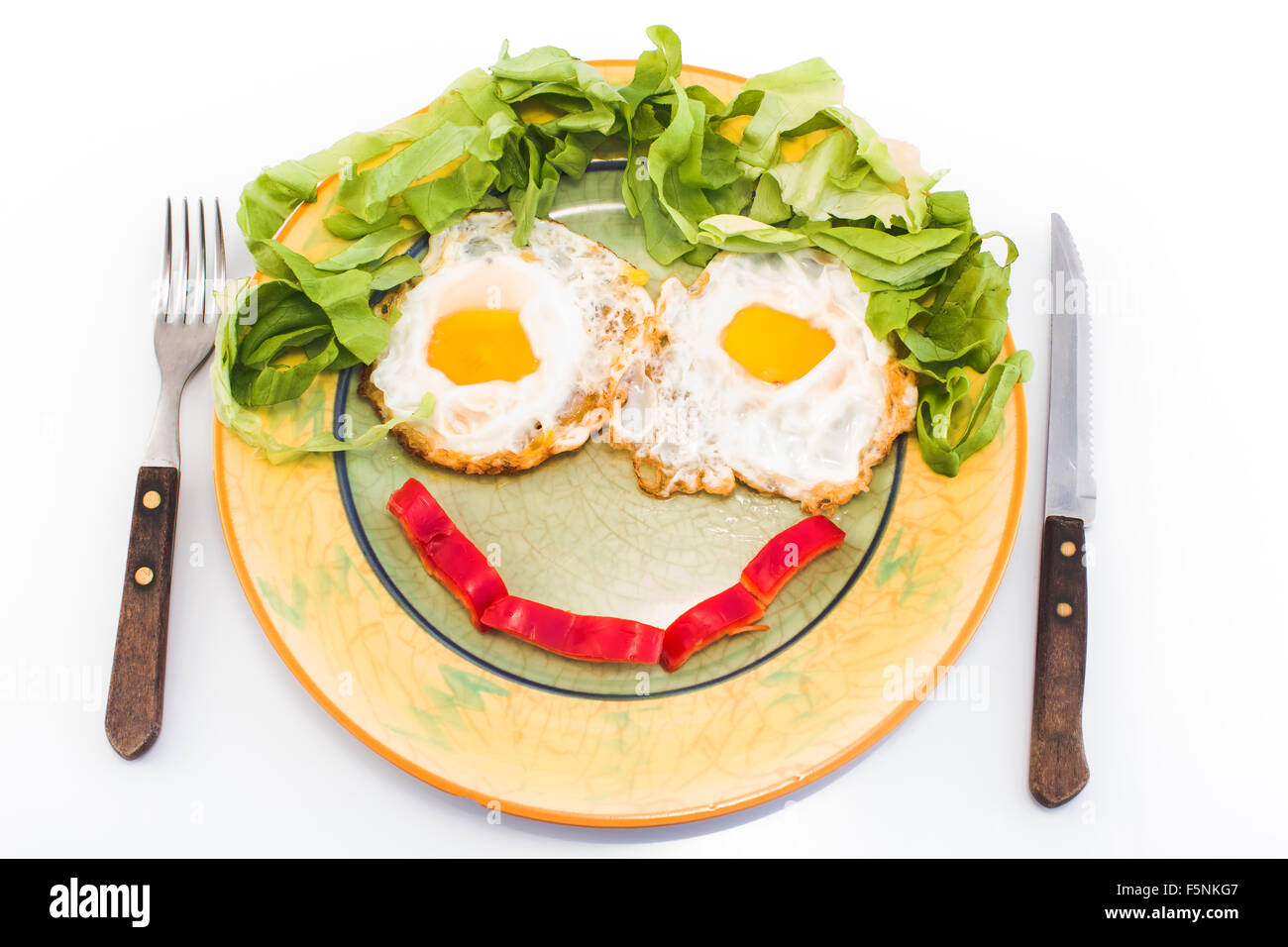 Smiley breakfast of eggs and lettuce Stock Photo - Alamy