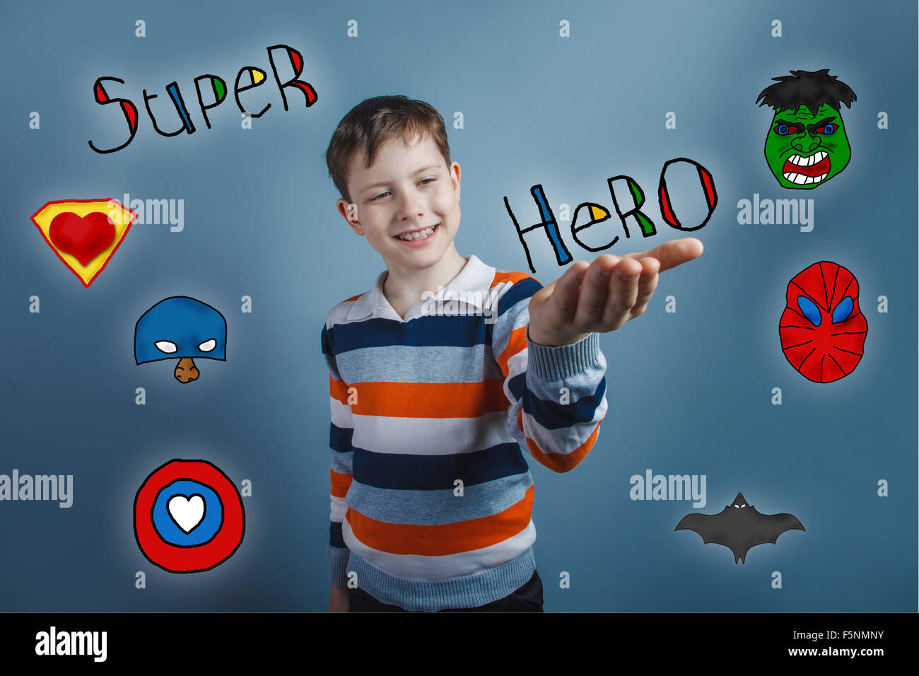boy smiling and holding his hand on the word superhero super pow Stock ...
