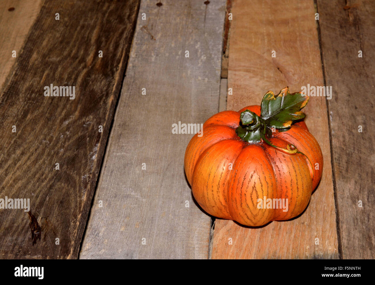 Autumn decoration of wooden orange pumpkin sitting on pallet wood Stock ...