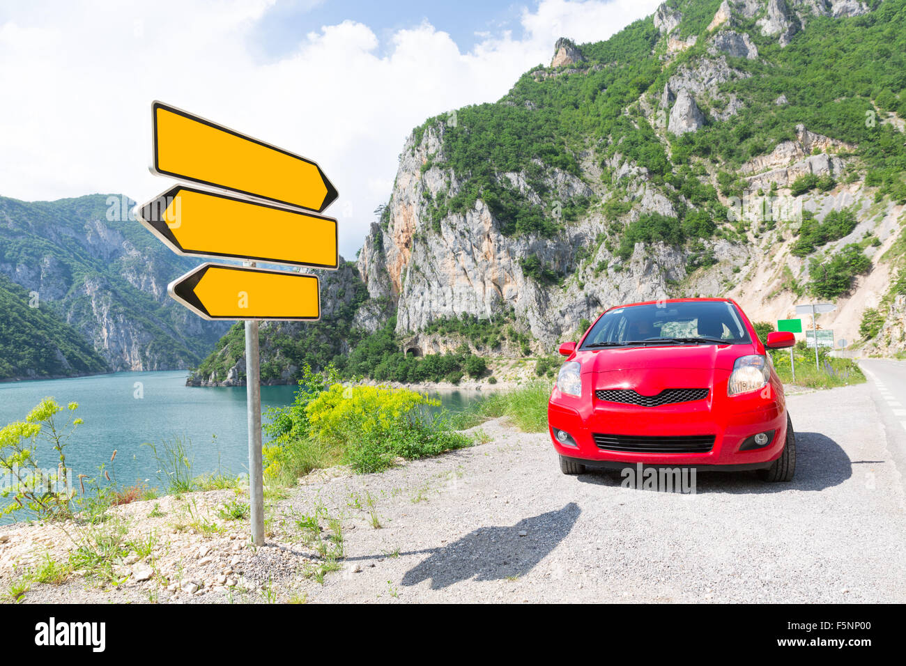 Car in mountains and road pointer Stock Photo - Alamy