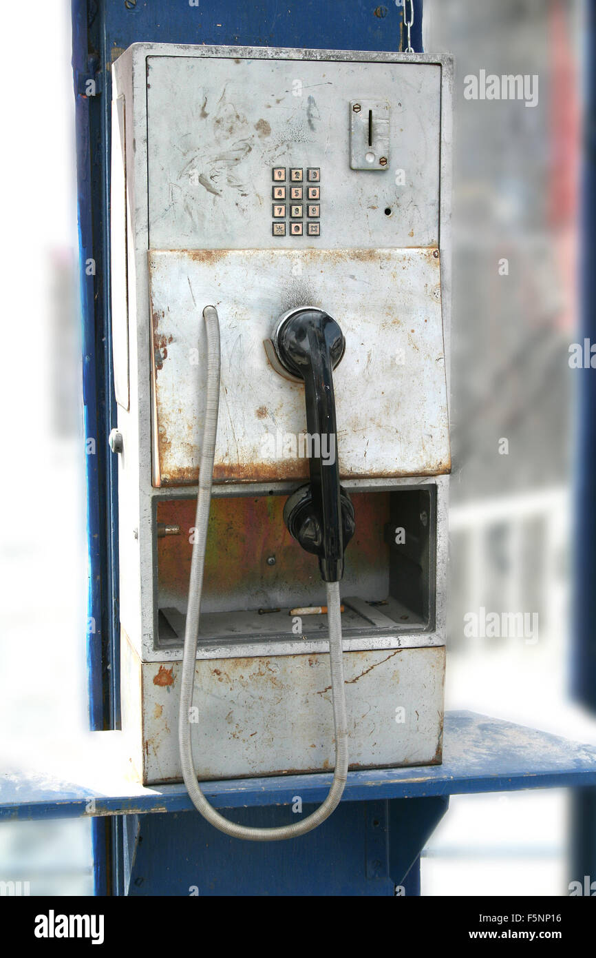 Old worn public phone in telephone box, souvenir of the communism era ...