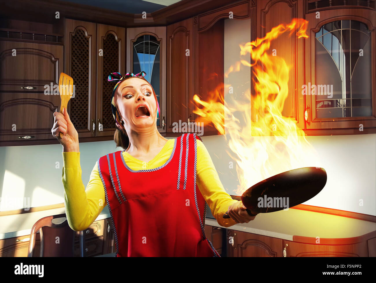 Housewife cooking on the kitchen with big fire Stock Photo - Alamy