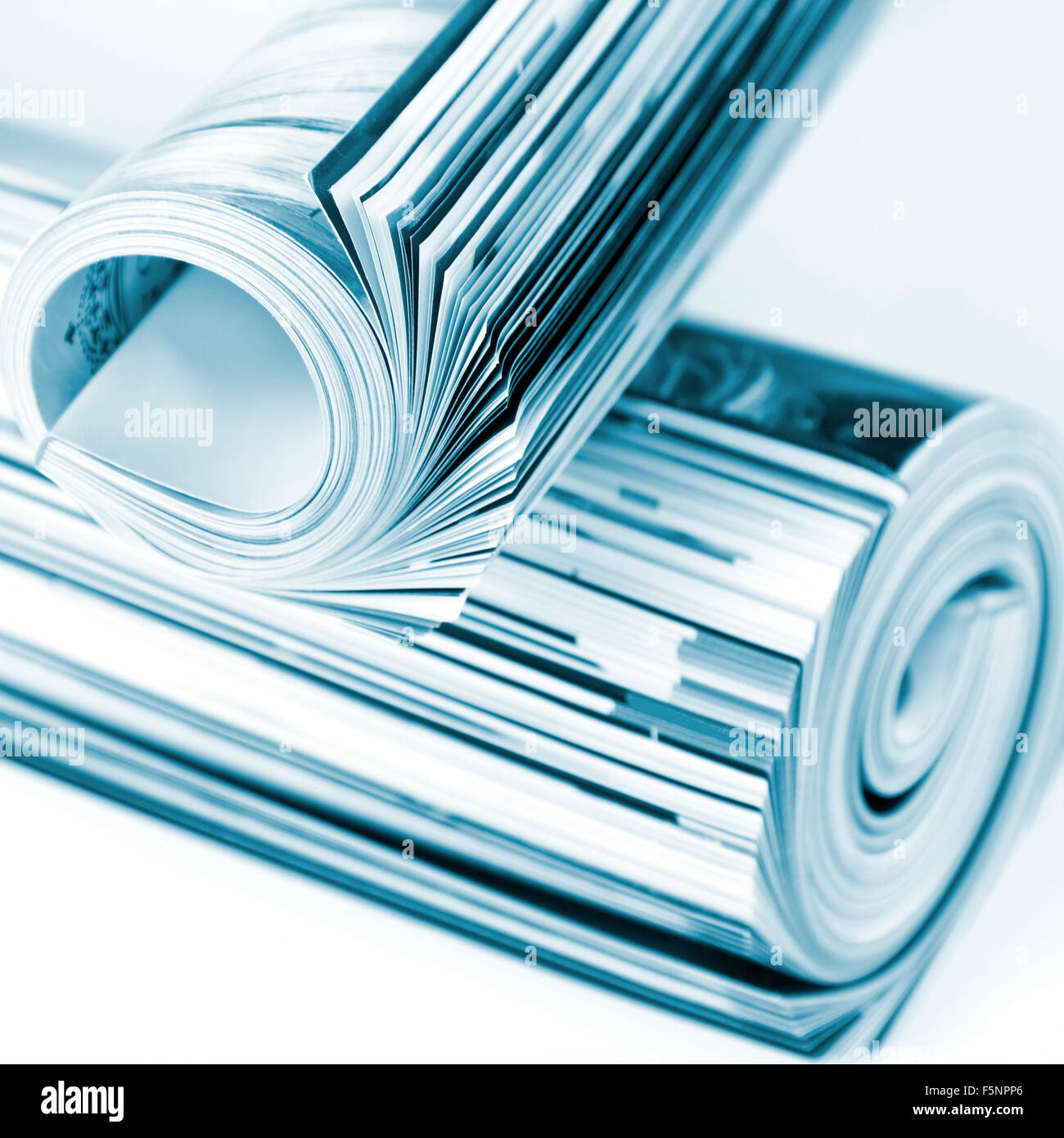 Rolled up magazines. Toned Stock Photo - Alamy