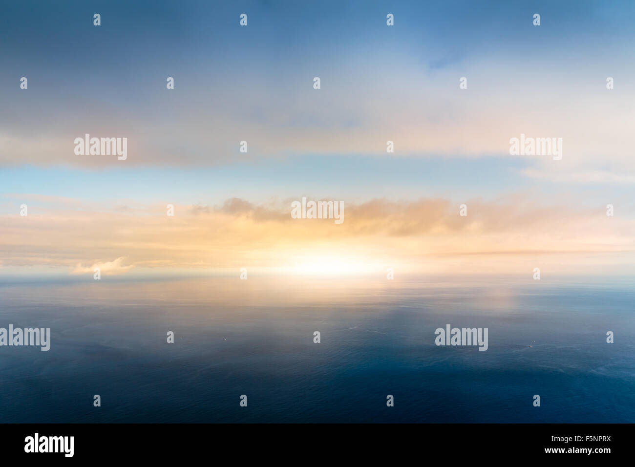 Cloudy sunrise sky and calm sea landscape Stock Photo - Alamy