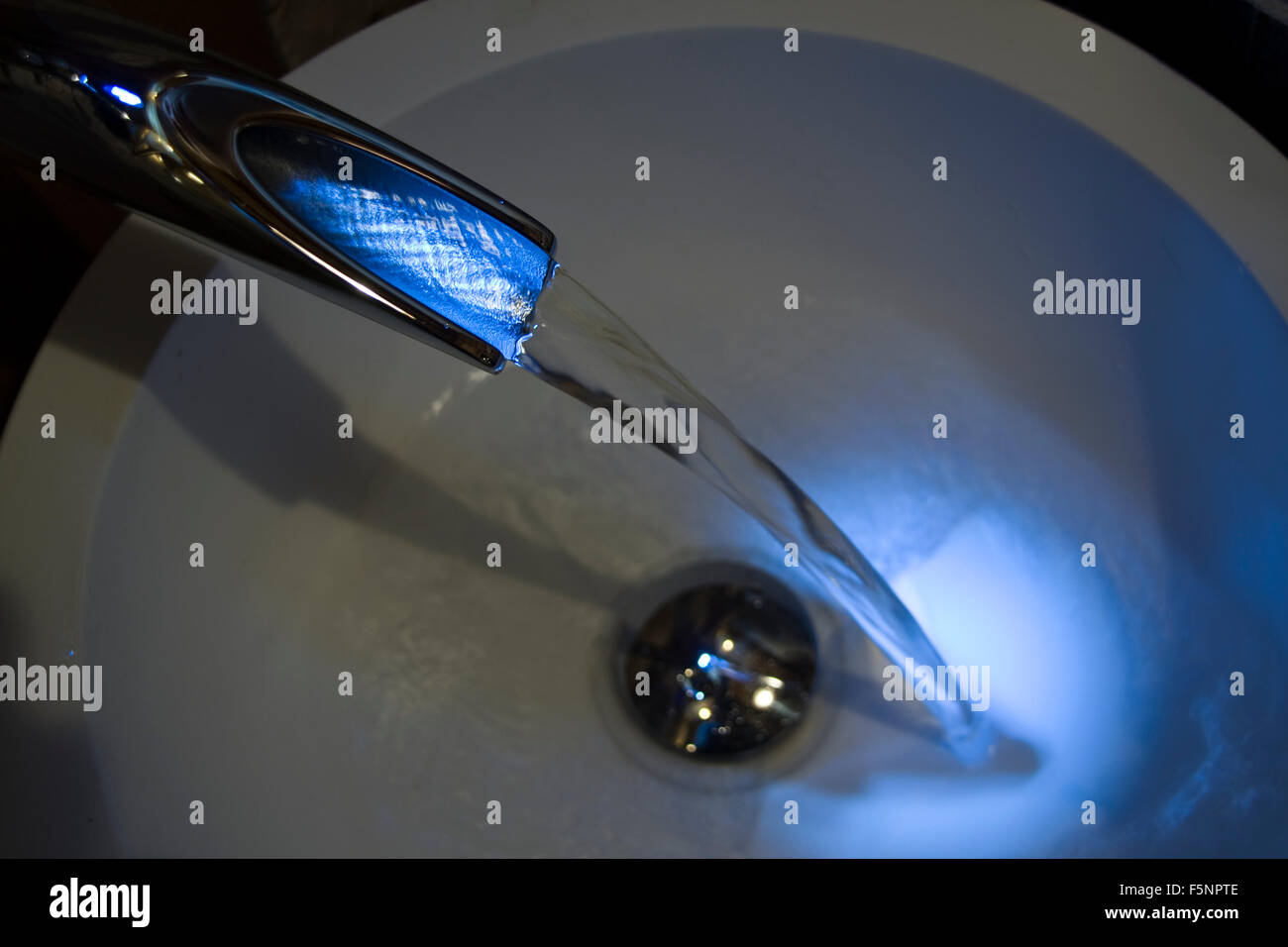Falling water. Blue light Stock Photo - Alamy