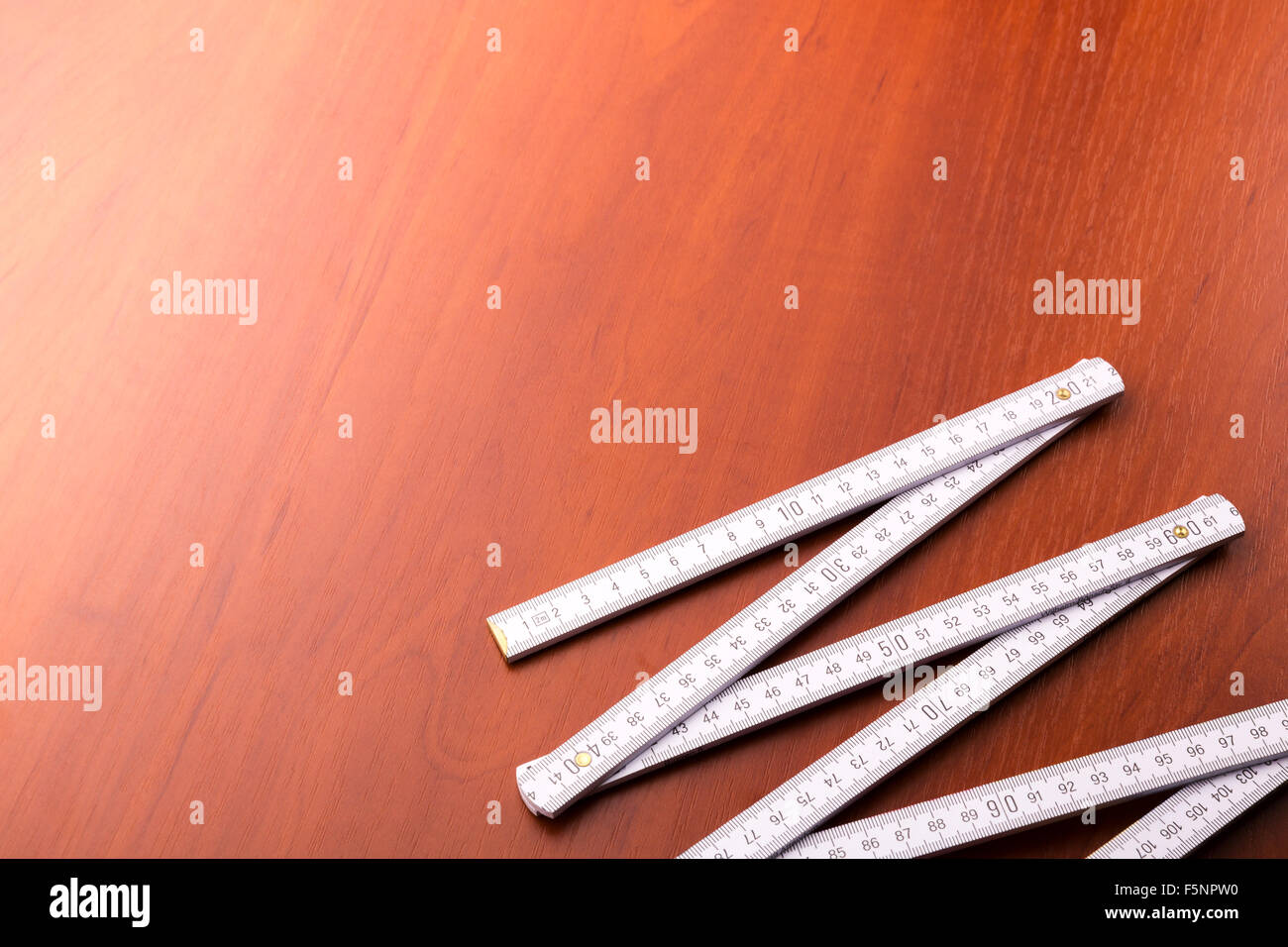 White measuring tepe on the wooden table Stock Photo - Alamy