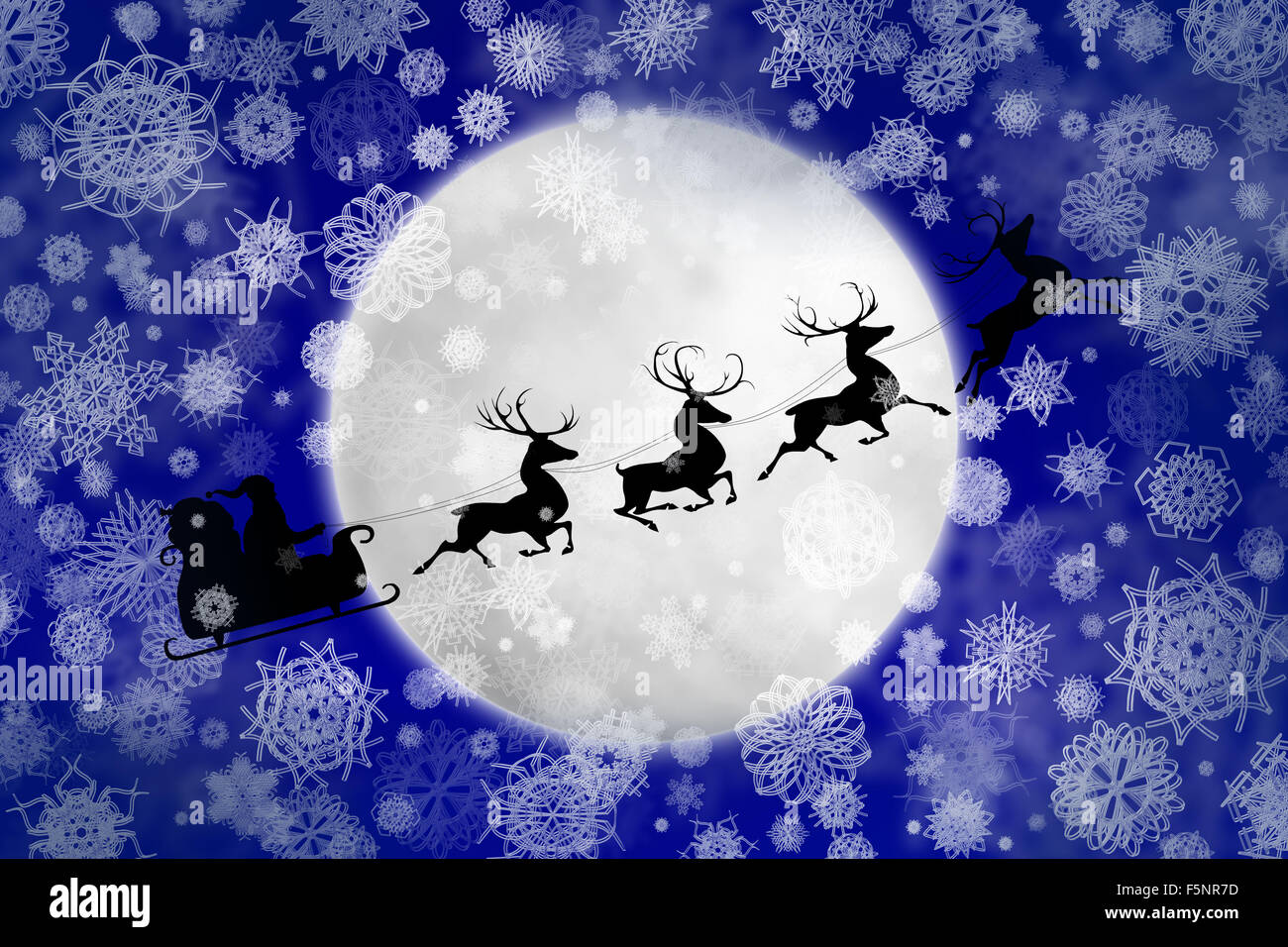 Santa and his reindeers riding against moon in snowfall Stock Photo - Alamy