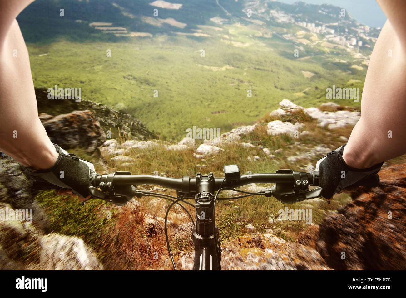 Man riding down on a bicycle in mountains Stock Photo - Alamy