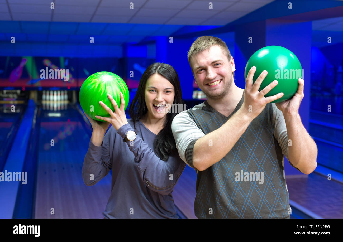 Happy couple in a bowling alley having fun Stock Photo - Alamy