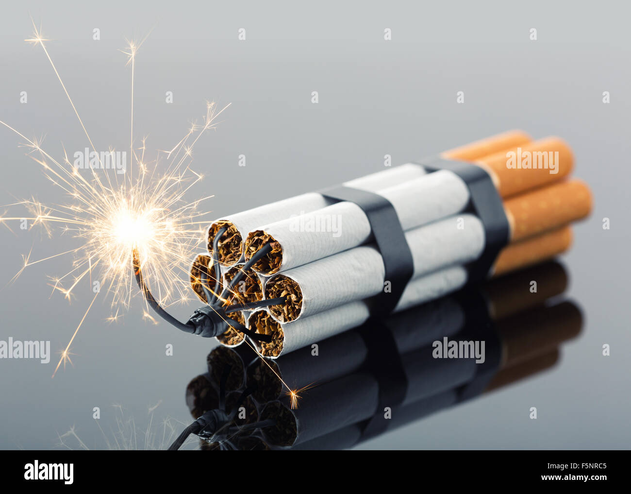 Explosives from cigarettes with sparks on gray Stock Photo - Alamy