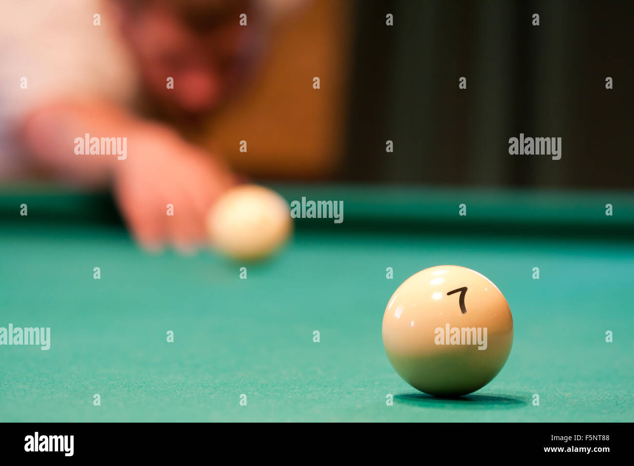 Billiard player concentrating and aiming to ball Stock Photo - Alamy