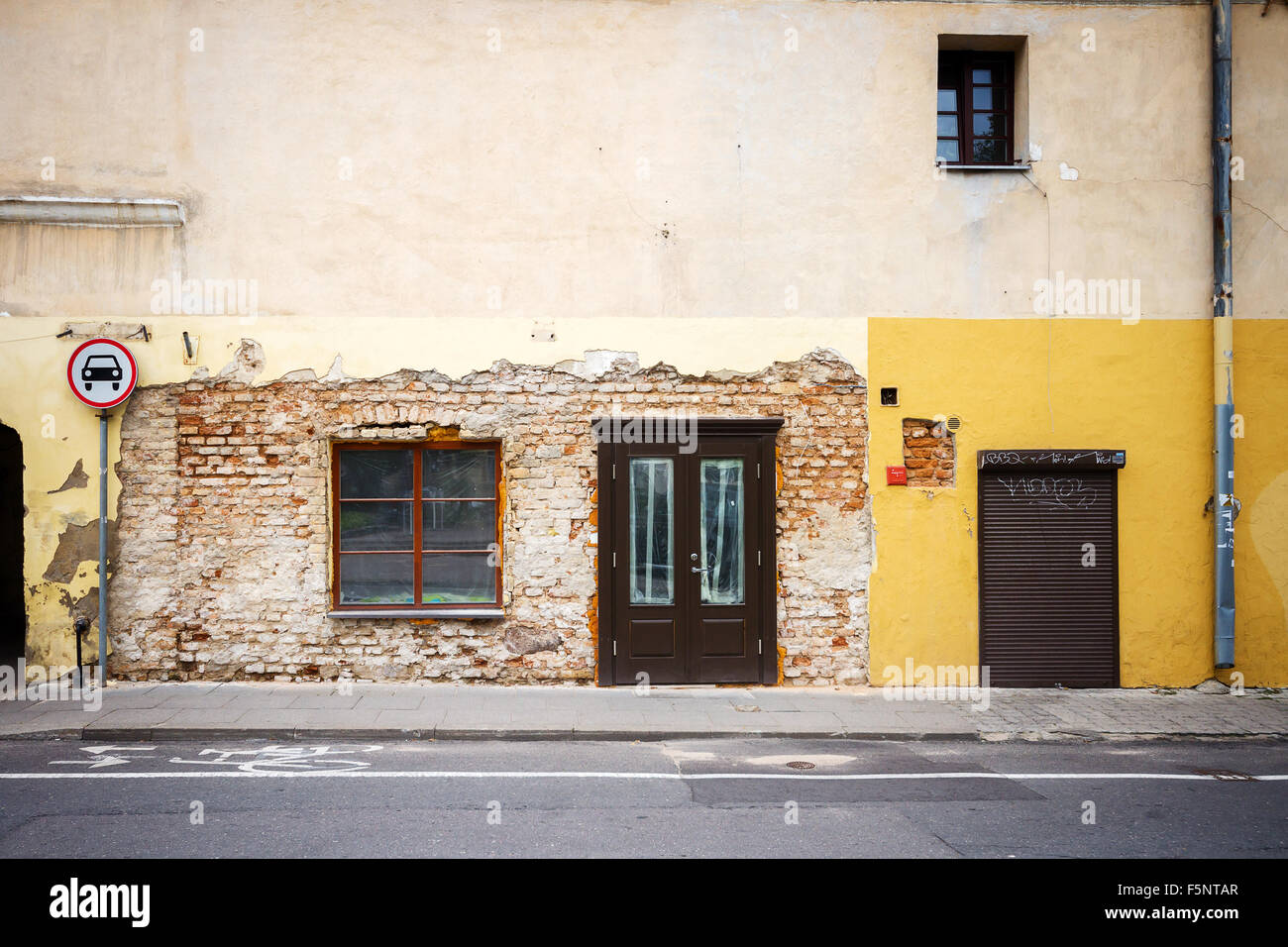 Old weathered street wall with some windows and doors Stock Photo - Alamy
