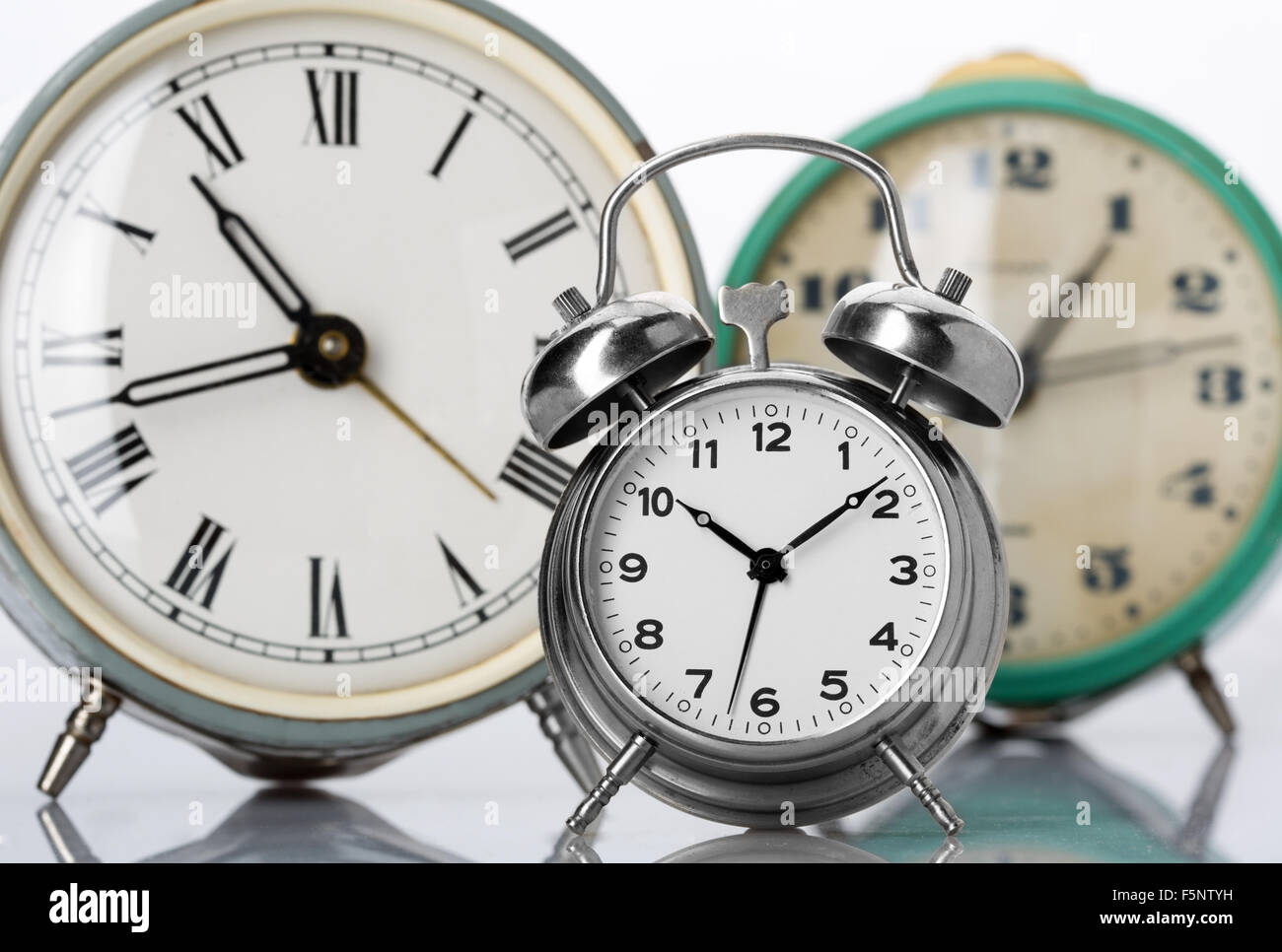 Three old classical alarm clocks Stock Photo - Alamy