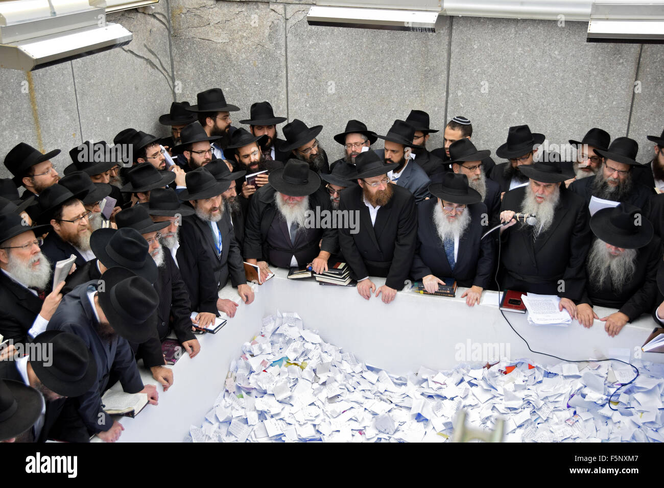 At the Ohel in Queens Rabbi Moshe Kotlarsky reads a prayer from all the ...