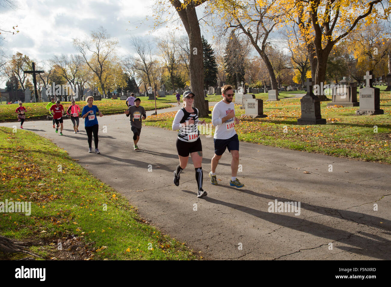 Detroit, Michigan USA. Runners in Holy Cross Cemetery during the annual ...