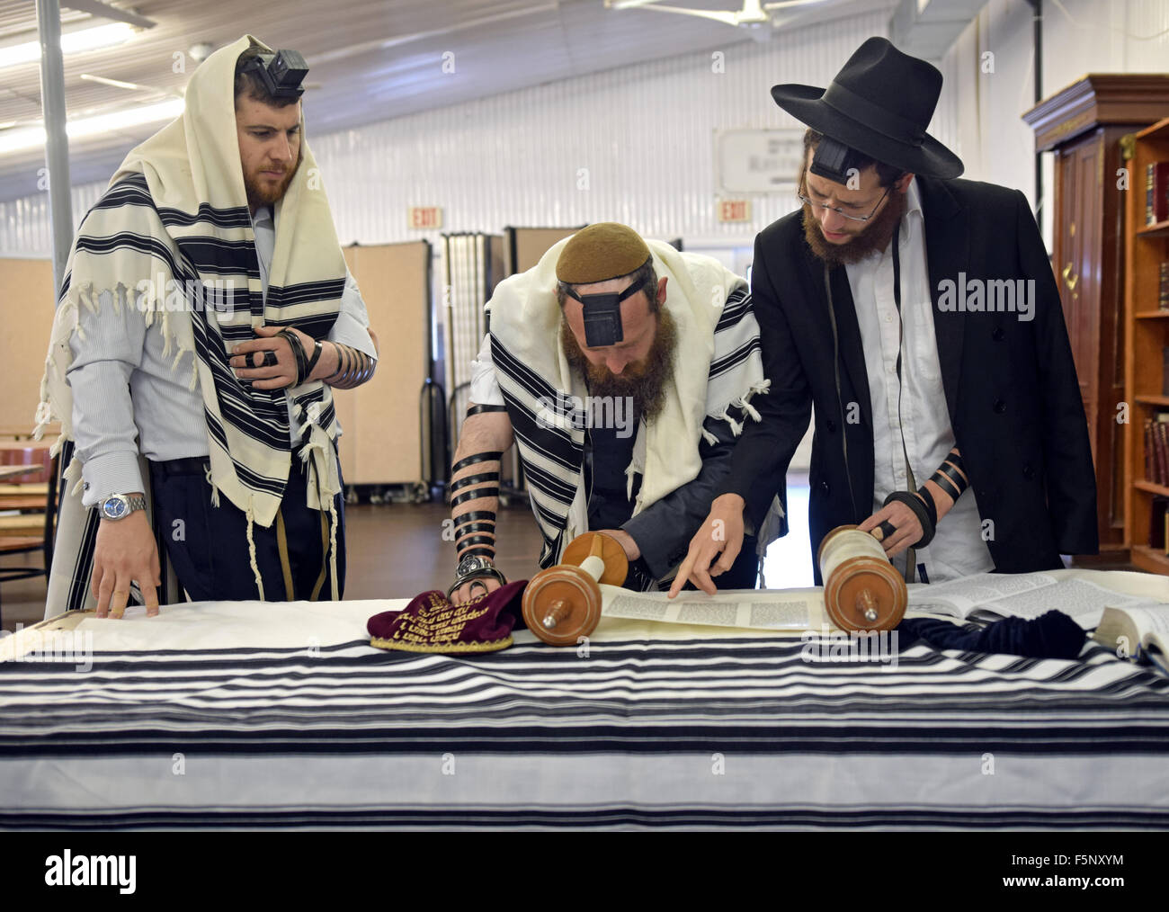 Torah reading during a small morning prayer service at the Ohel in ...