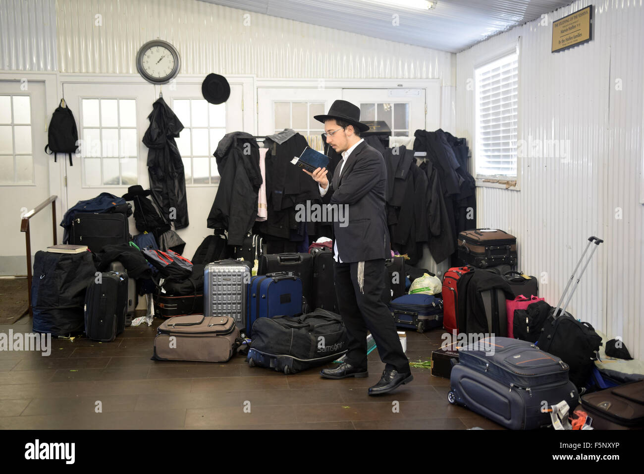 A religious Jewish young man prays at a small synagogue at the Ohel at ...