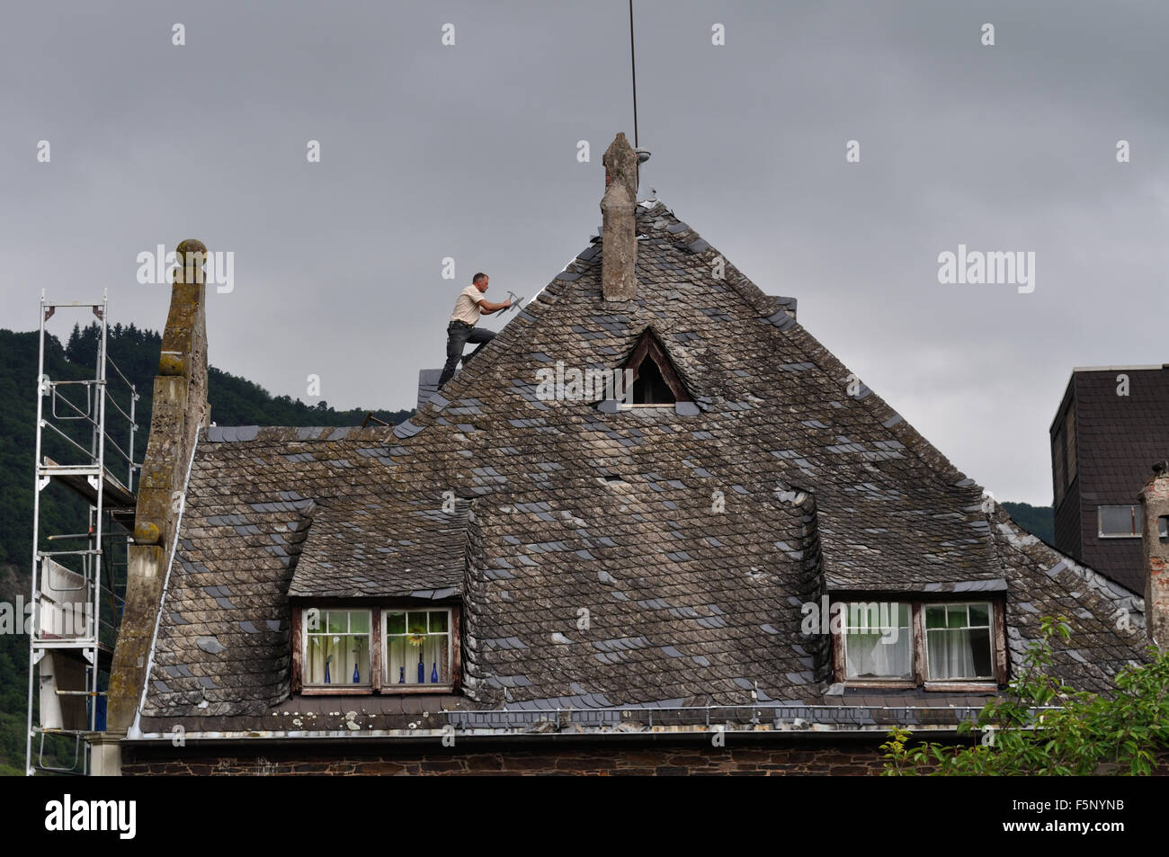 A workman carries out repairs to the roof of the historic Mustard Mill ...