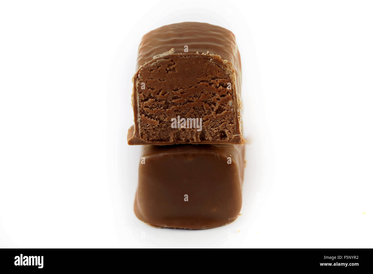 Chocolate enrobed milk cheese photographed close up on a white ...