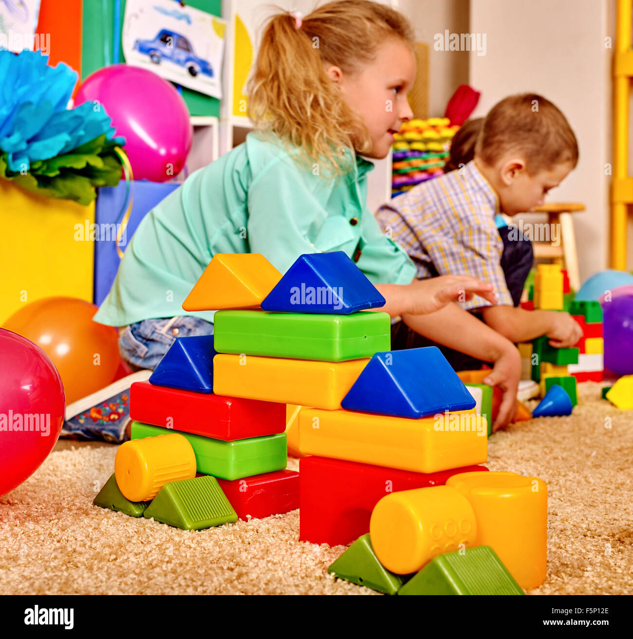 Group children game blocks on floor Stock Photo - Alamy
