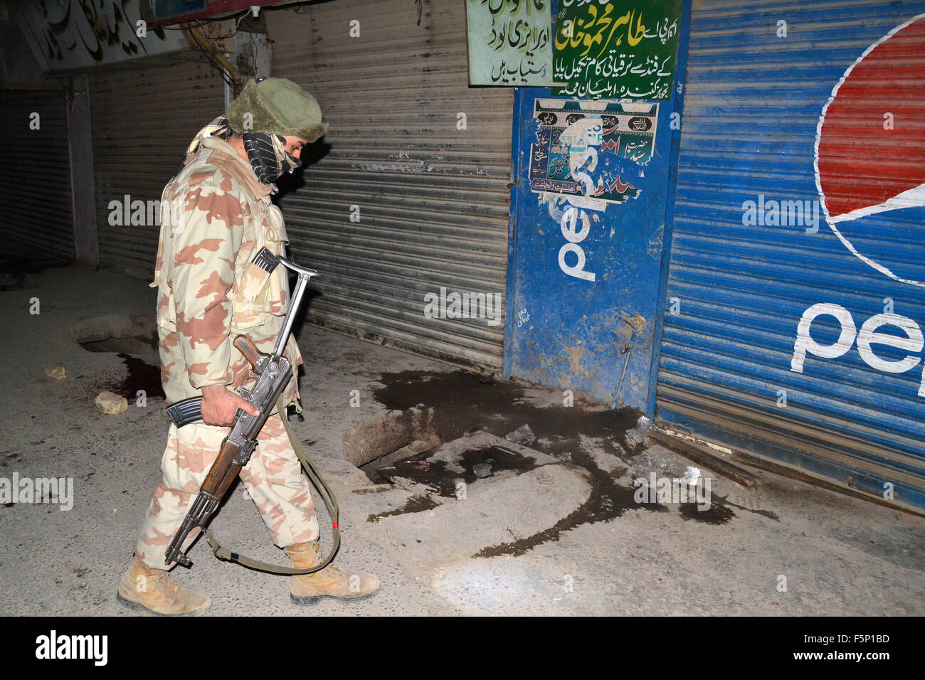 Quetta. 7th Nov, 2015. A security official examines the attack site in ...