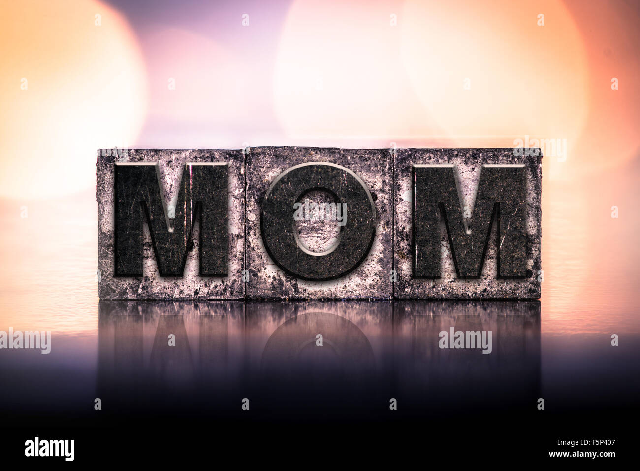 The word "MOM" written in vintage ink stained letterpress type Stock ...